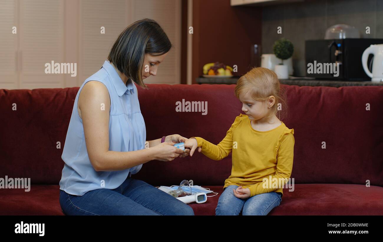 Mother measuring, monitoring oxygen saturation with digital pulse ...