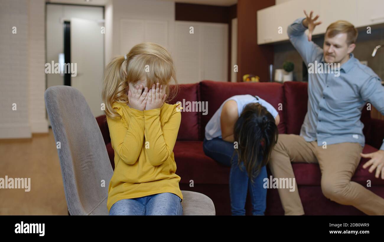 Caucasian child girl kid is suffering and crying from quarrels between ...