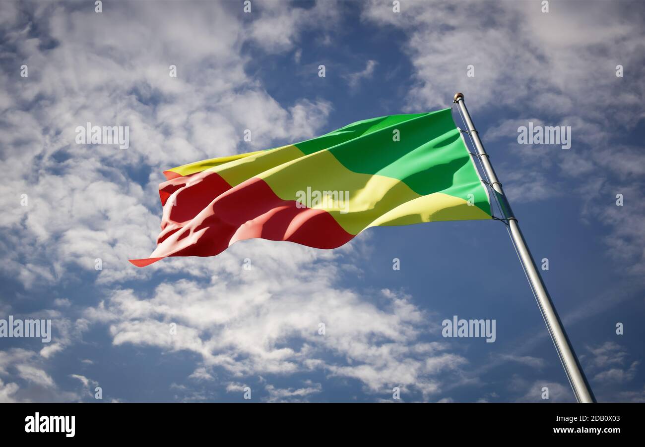 Beautiful national state flag of Congo fluttering at sky background ...