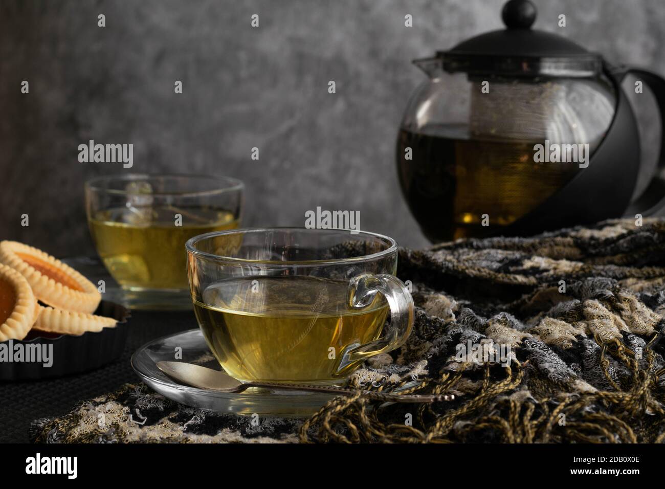 Relaxing tea time concept. Dark mood view of herbal tea and cookies ...