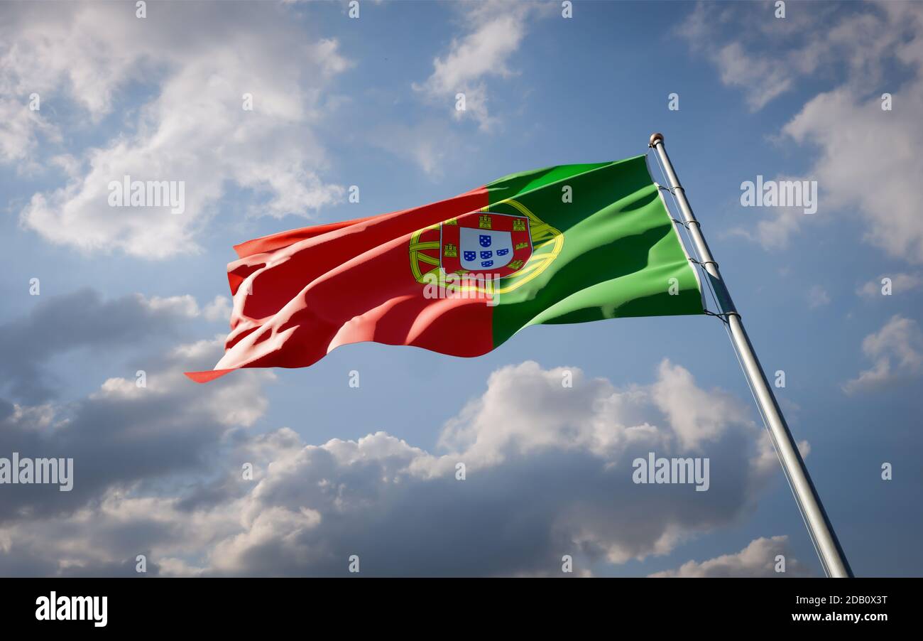Beautiful national state flag of Portugal fluttering at sky background ...
