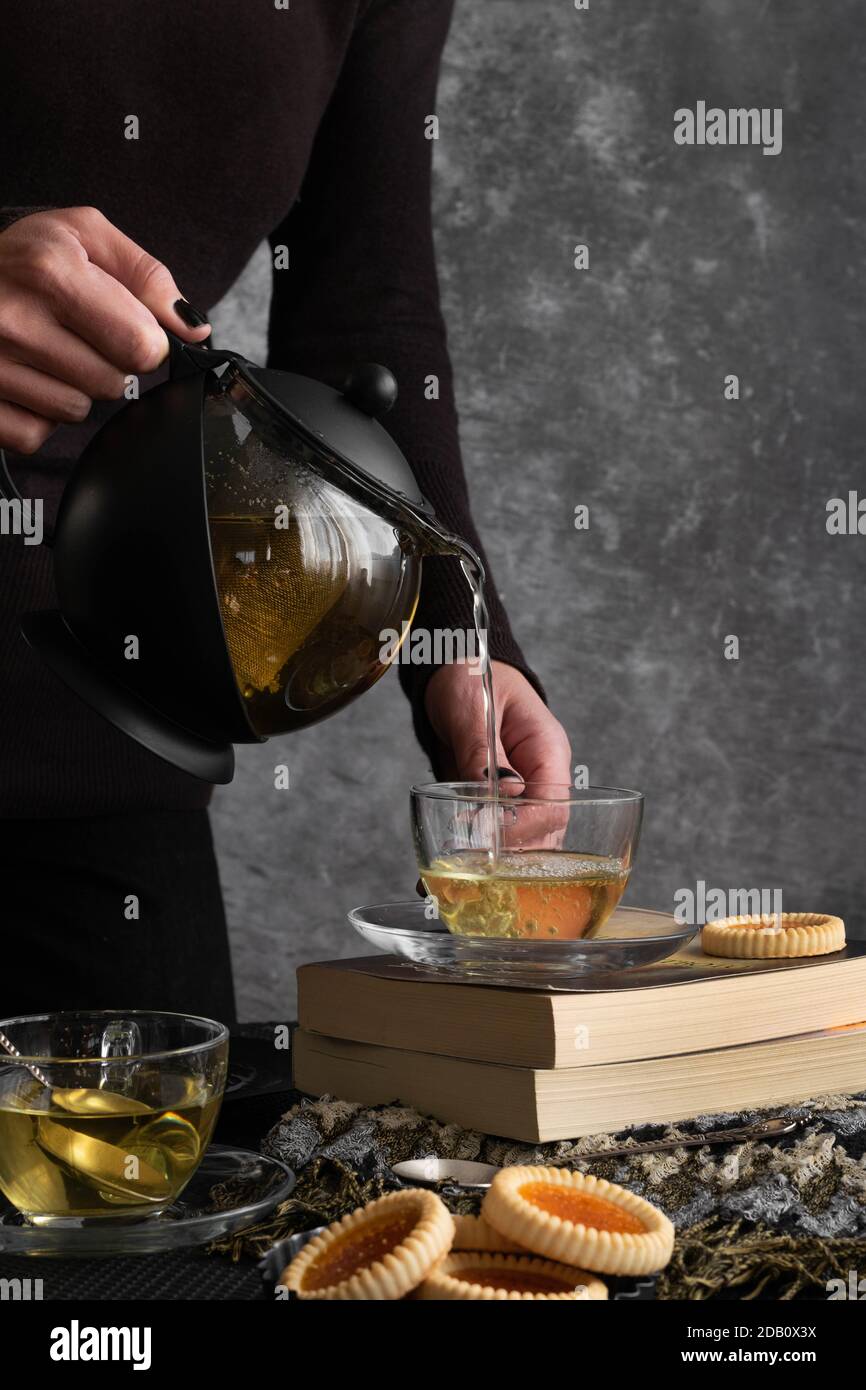 Woman hands pouring tea from a teapot Stock Photo - Alamy