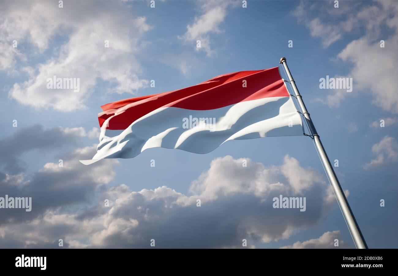 Beautiful national state flag of Monaco fluttering at sky background ...