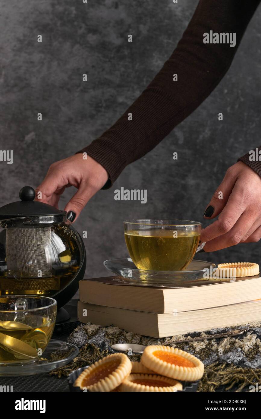 Woman hands pouring tea from a teapot Stock Photo - Alamy