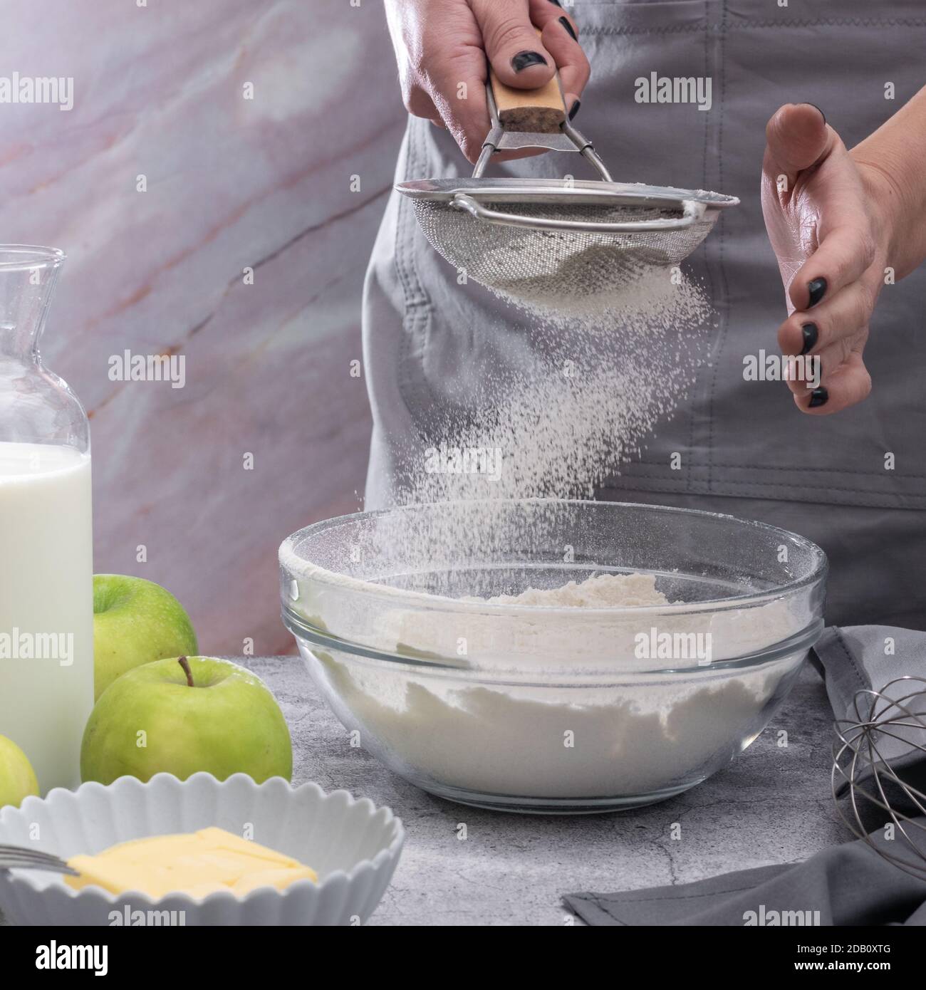 Woman sifting flour through sieve, preparing homemade sweet pie with ...