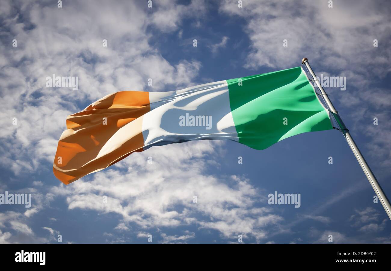 Beautiful national state flag of Ireland fluttering at sky background ...