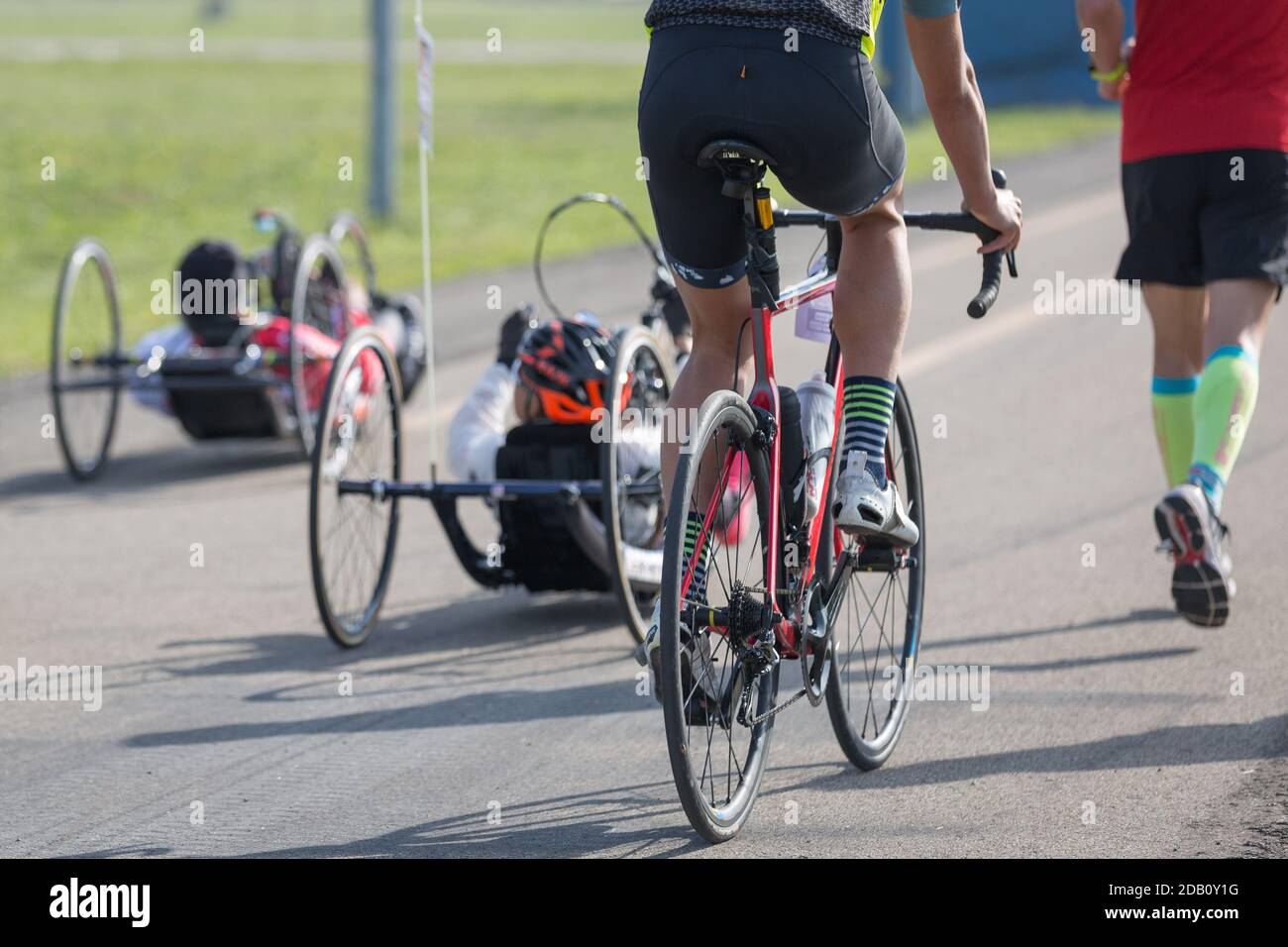 Disabled Athletes training with their Handbike with Cyclist and Runners ...