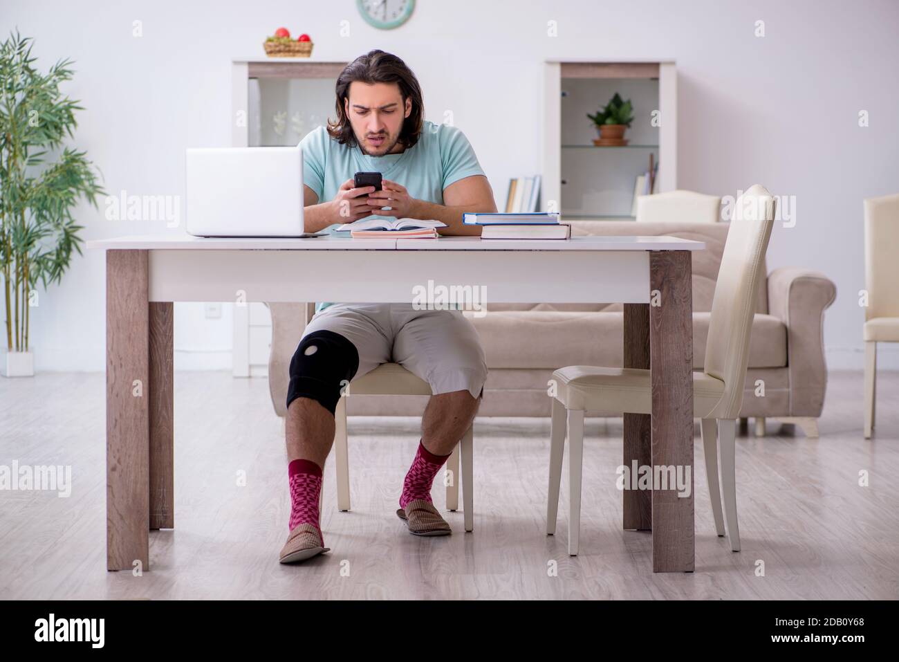 Young leg injured student studying at the home Stock Photo - Alamy