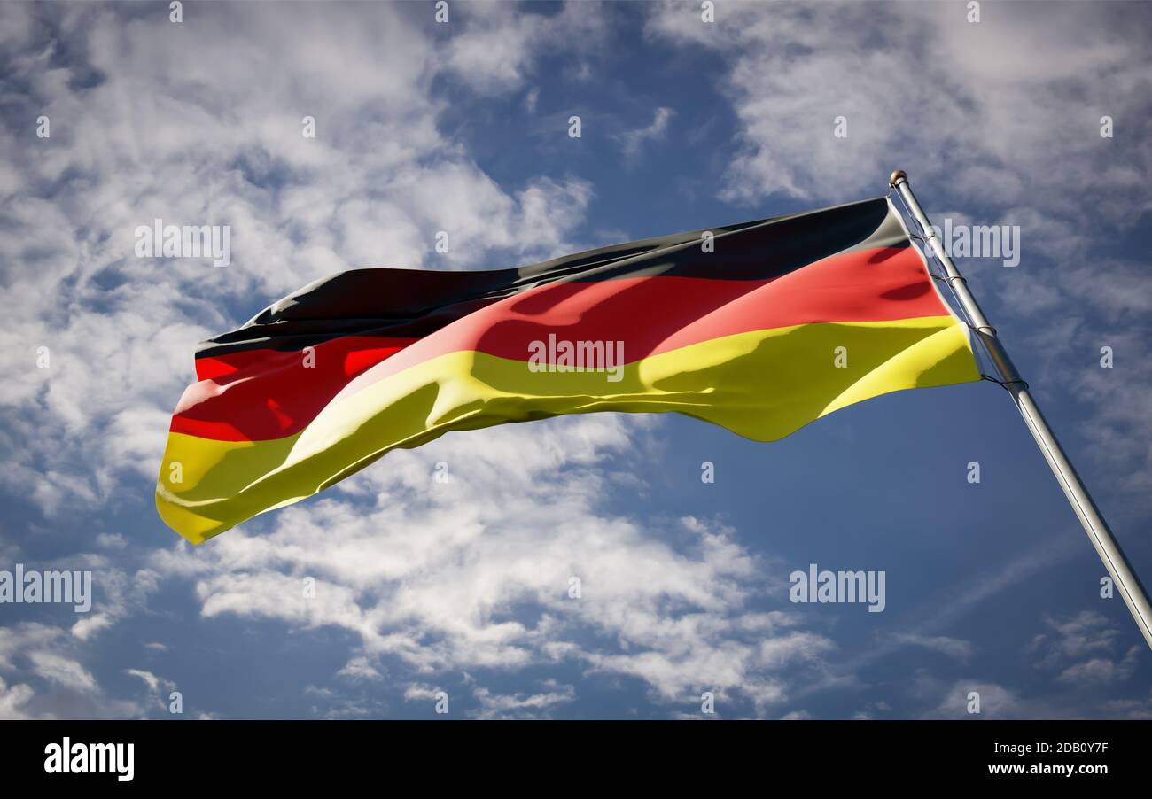 Beautiful national state flag of Germany fluttering at sky background ...