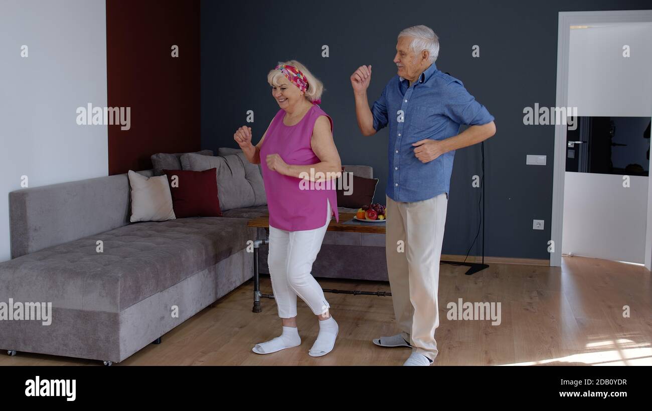 Happy old senior couple dancing celebrating retirement anniversary in ...
