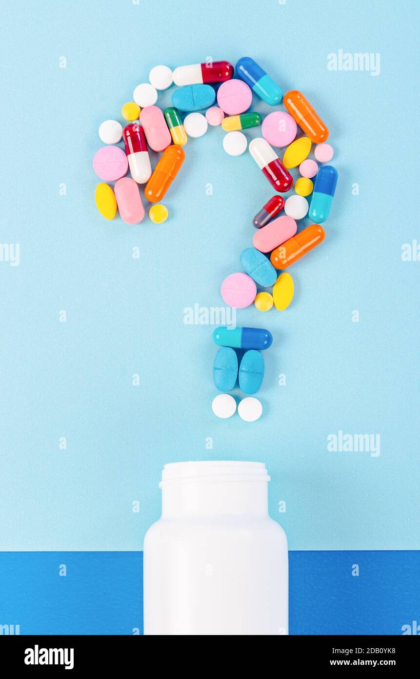 A question mark from laid out of medicine pills with bottle drug on ...