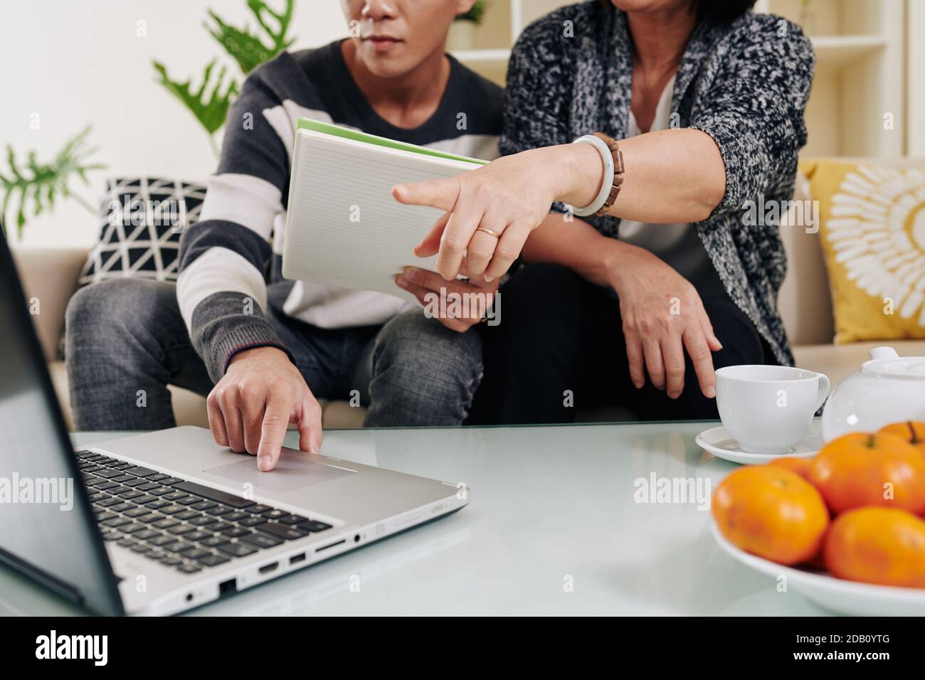 Helping mother with laptop Stock Photo - Alamy