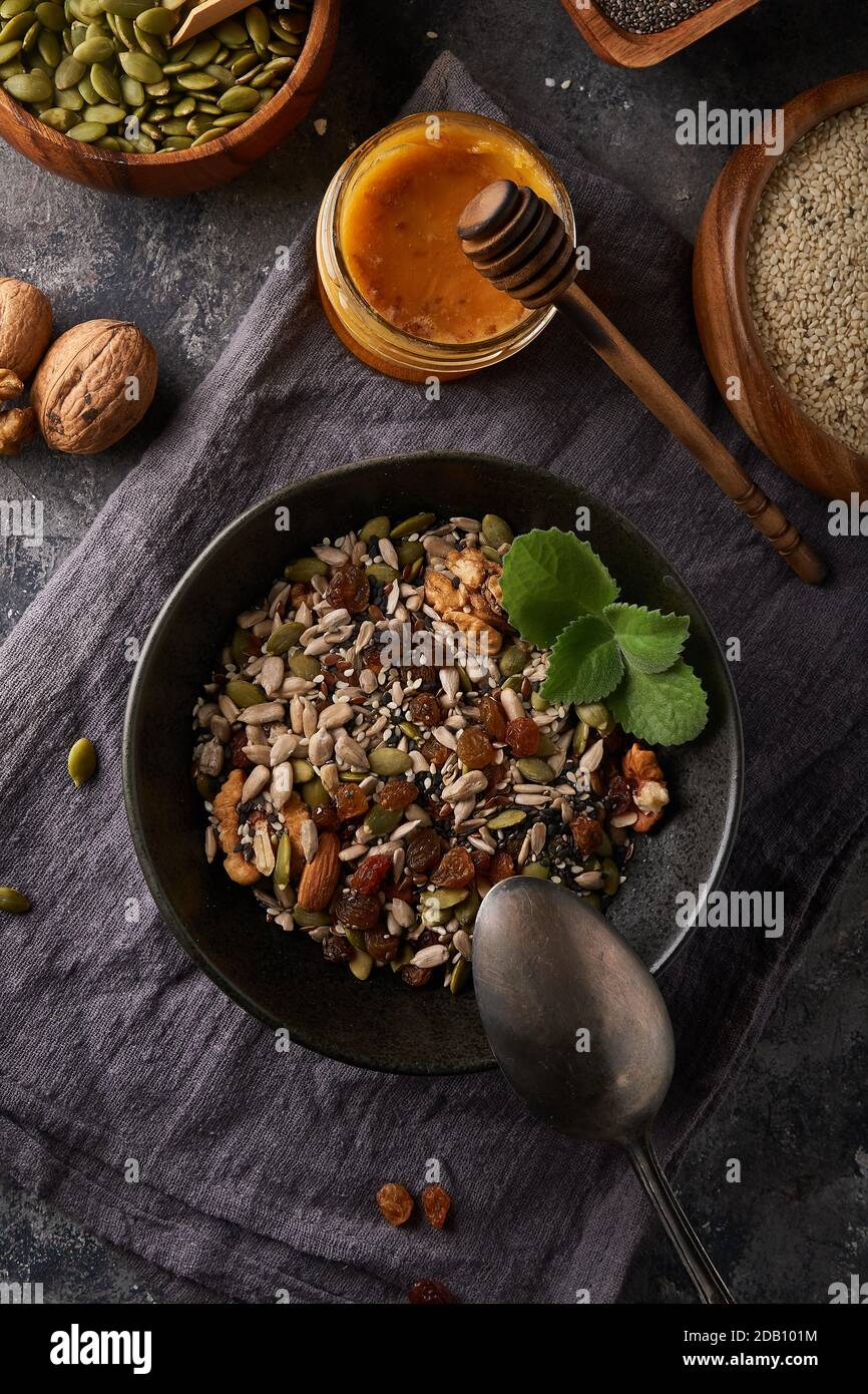 Healthy breakfast, seed and nut mix with honey and mint Stock Photo - Alamy