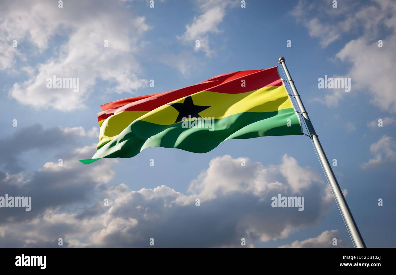 Beautiful national state flag of Ghana fluttering at sky background ...