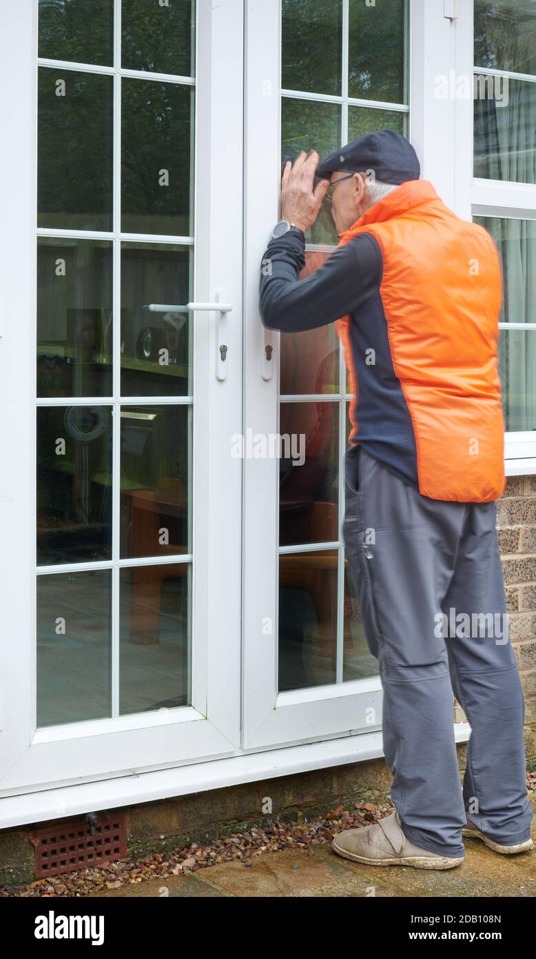 Suspicious man at door hi-res stock photography and images - Alamy