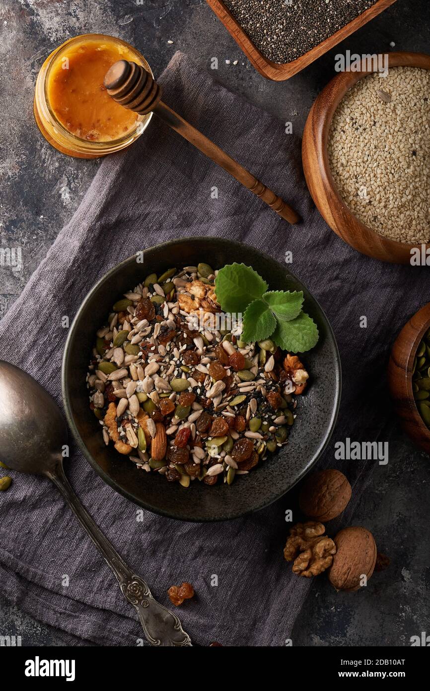 Healthy breakfast, seed and nut mix with honey and mint Stock Photo - Alamy