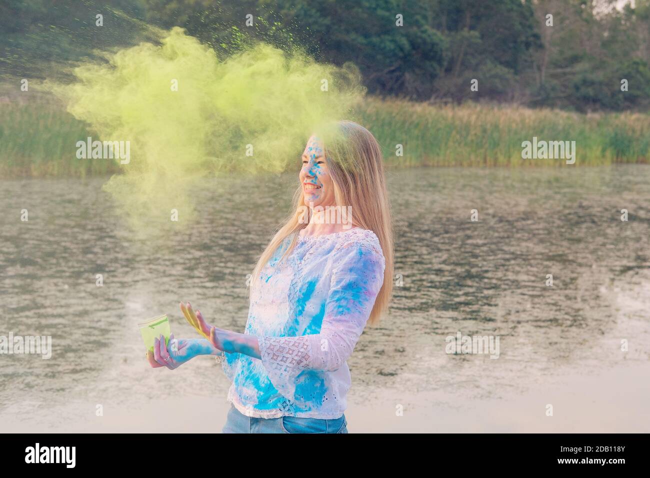 Blond lady with colorful dust on face Stock Photo - Alamy