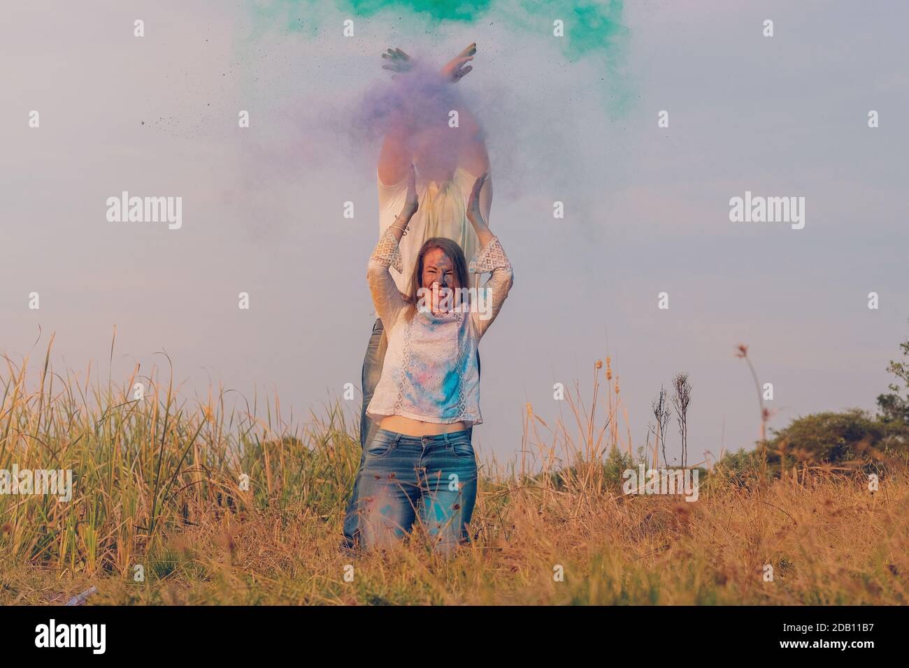Blond lady with colorful dust on face Stock Photo - Alamy