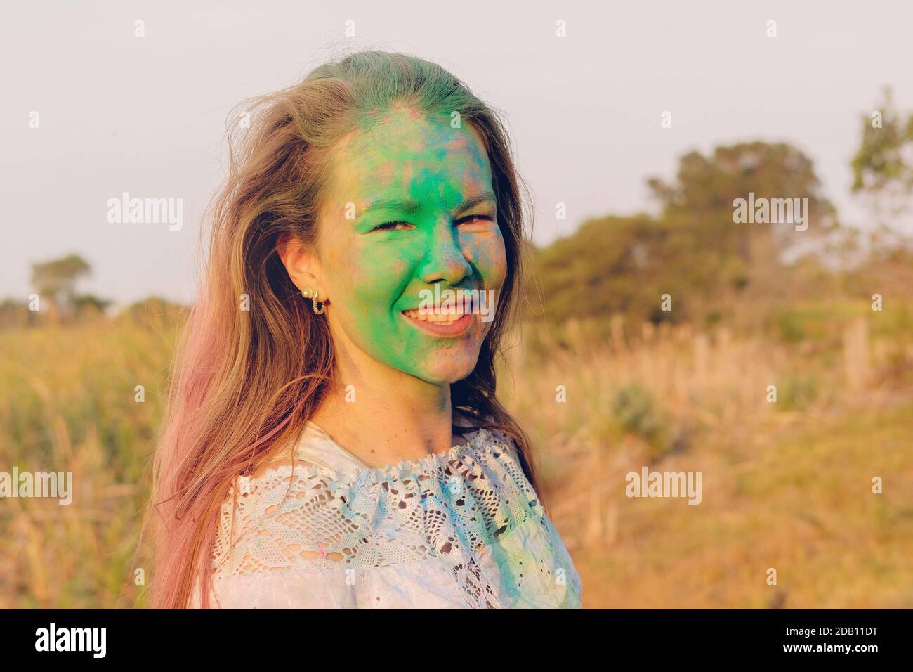 Blond lady with colorful dust on face Stock Photo - Alamy