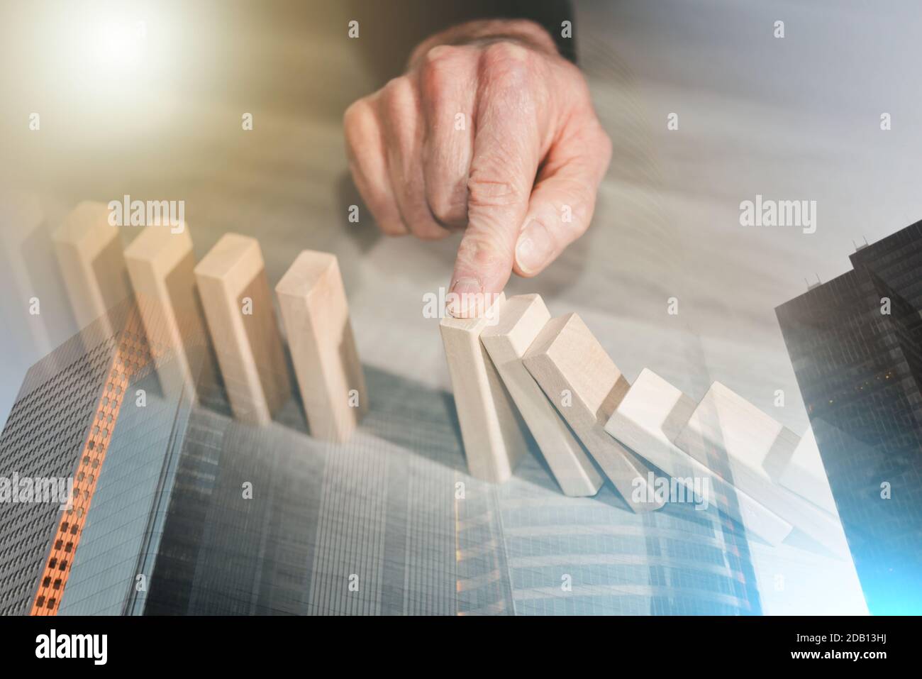 Male hand stopping domino effect. concept of business control; multiple ...