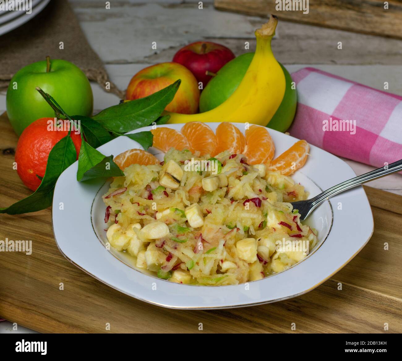 healthy fruit salad with rasped red and green apples, bananas and ...