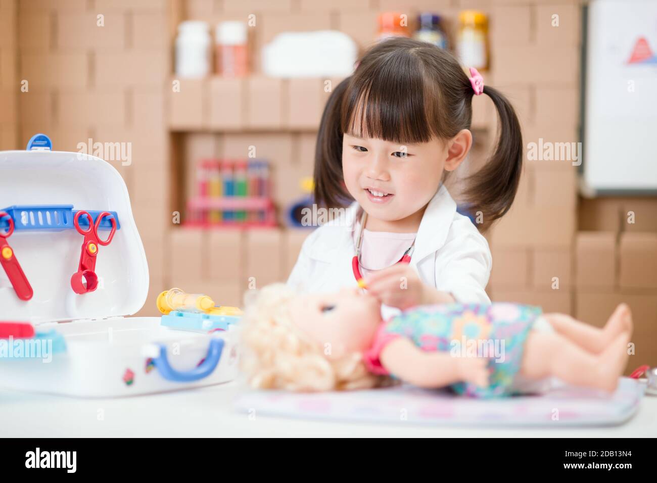 young girl pretend play doctor role at home Stock Photo - Alamy
