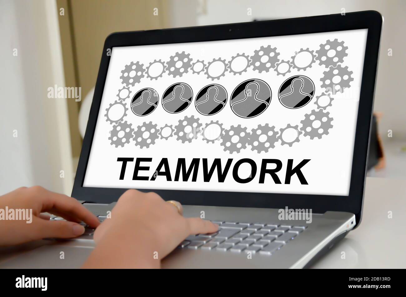 Hands on a laptop with screen showing teamwork concept Stock Photo - Alamy