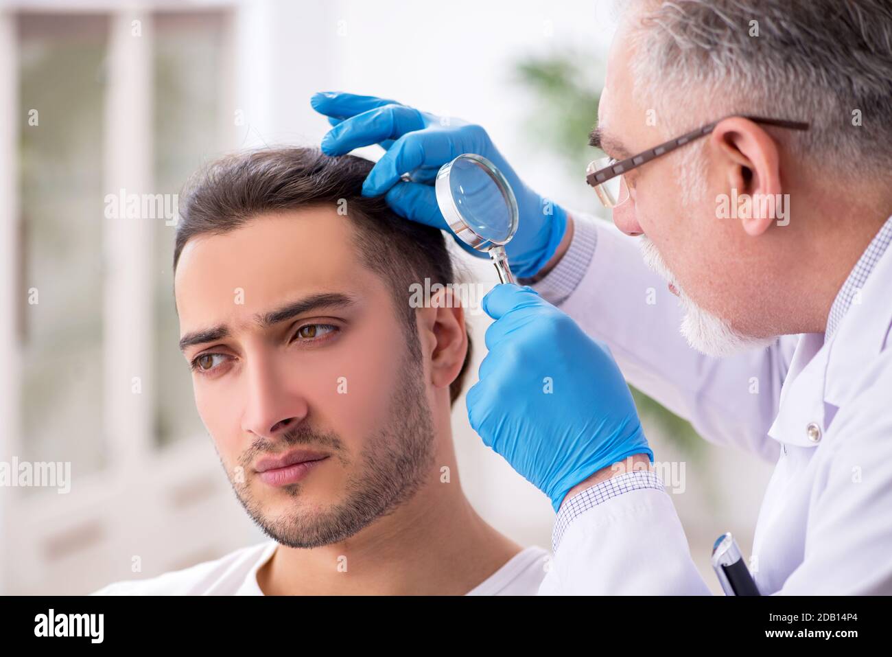 Young man visiting old doctor dermatologist Stock Photo - Alamy