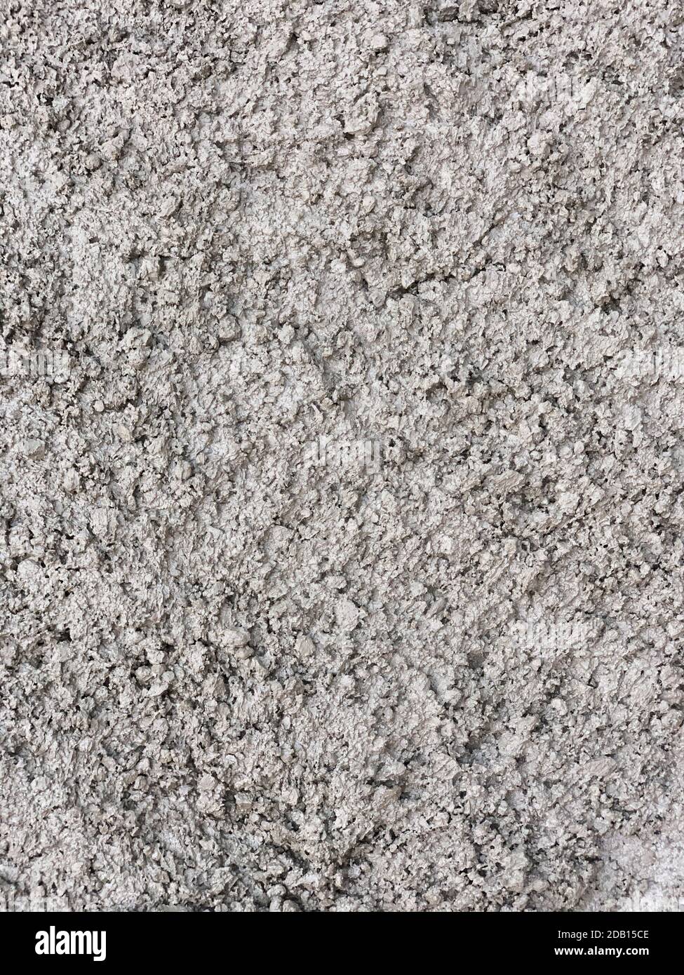 A vertical shot of freshly laid concrete with porous texture at ...