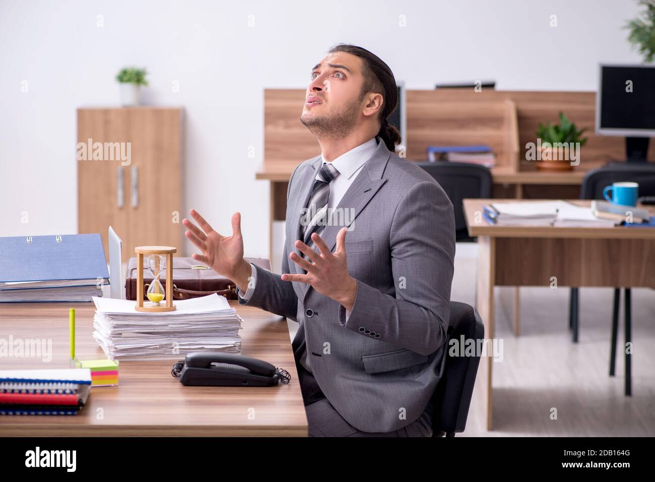 Young male employee working in the office environment Stock Photo - Alamy