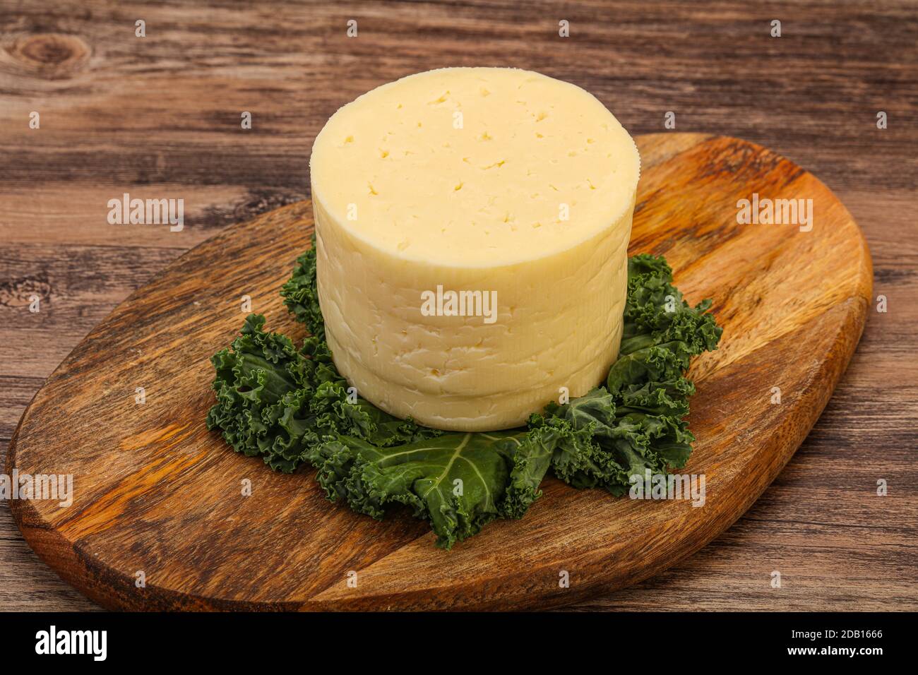 Yellow round dairy soft cheese piece Stock Photo - Alamy