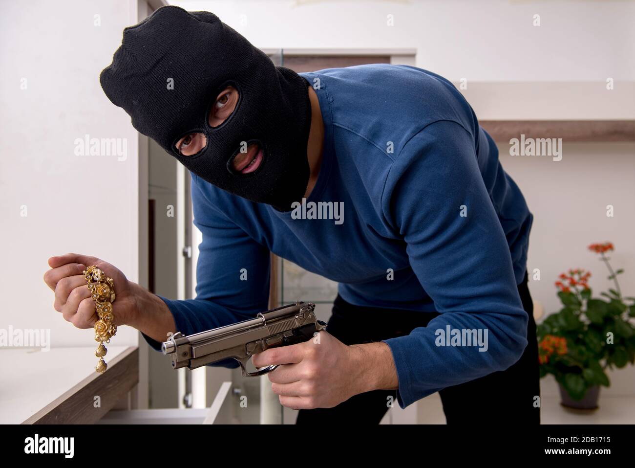Robber stealing valuable things from the house Stock Photo - Alamy