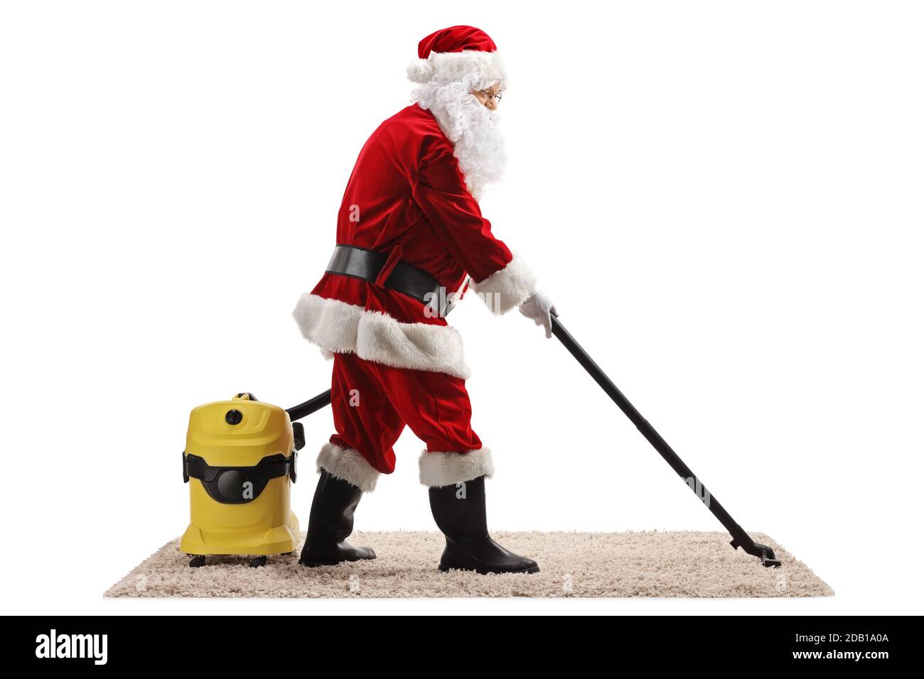 Full length profile shot of santa claus dusting a carpet with a vacuum ...