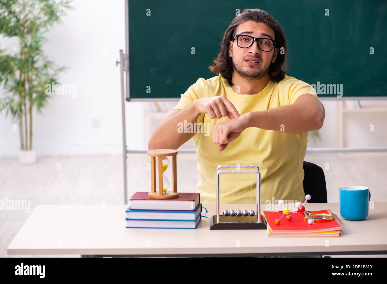 Male student physicist preparing for exams in the classroom Stock Photo ...