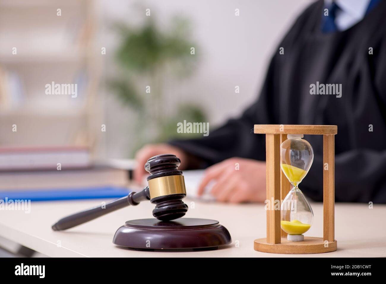 Young judge in time management concept Stock Photo - Alamy