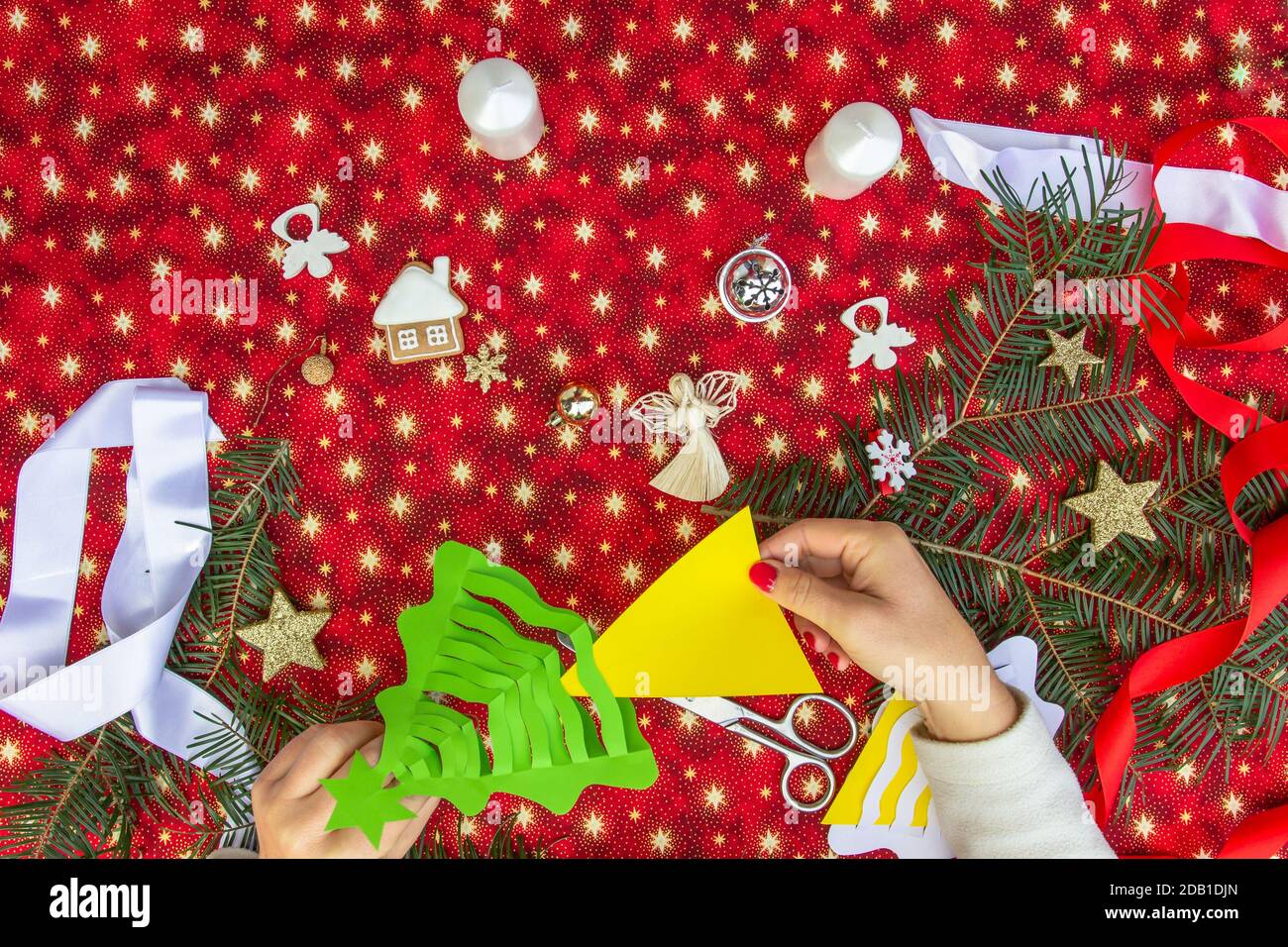 Christmas background with homemade 3D Christmas tree.Hands of woman ...