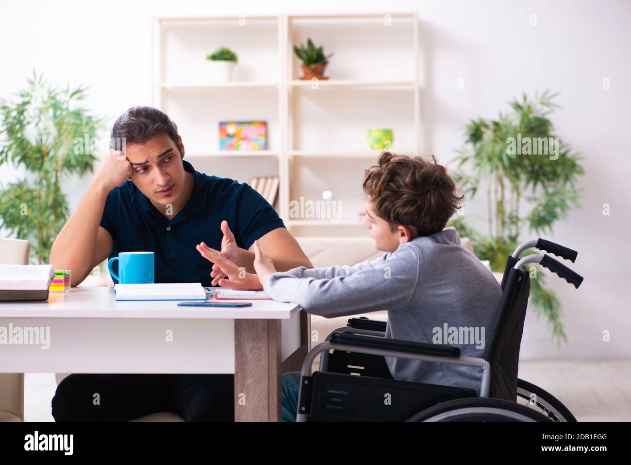 Father and disabled son in the education concept Stock Photo - Alamy