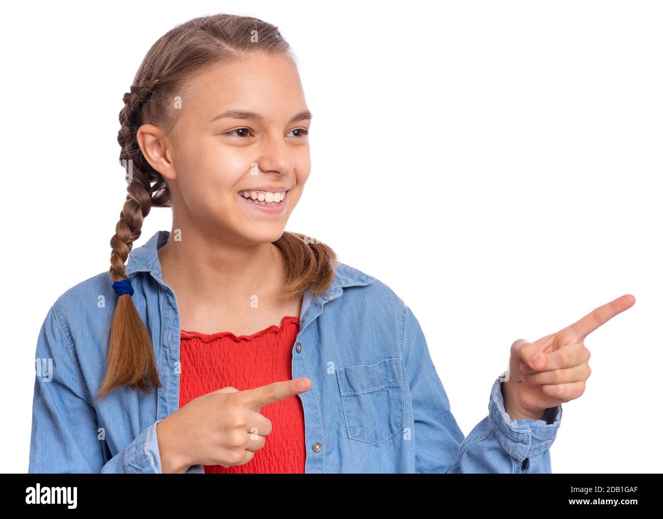 Happy teenage girl pointing up, gesturing idea or doing number one ...