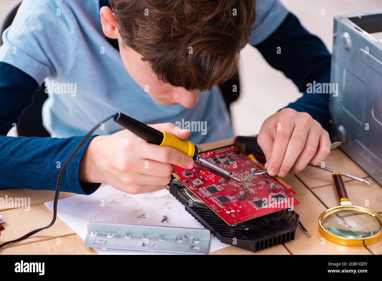 Teenager reparing computers at workshop Stock Photo - Alamy
