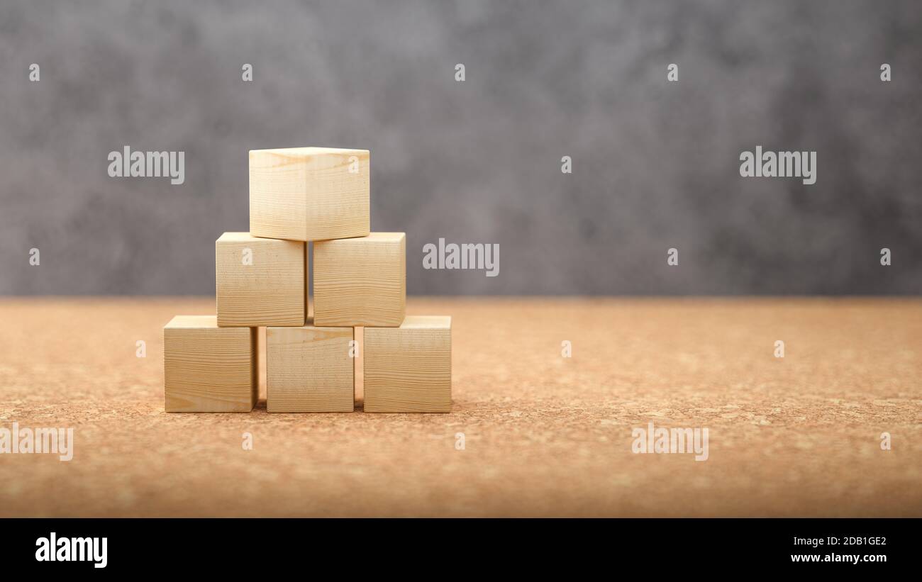 empty wooden cubes for own messages and icons on cork floor in front of ...