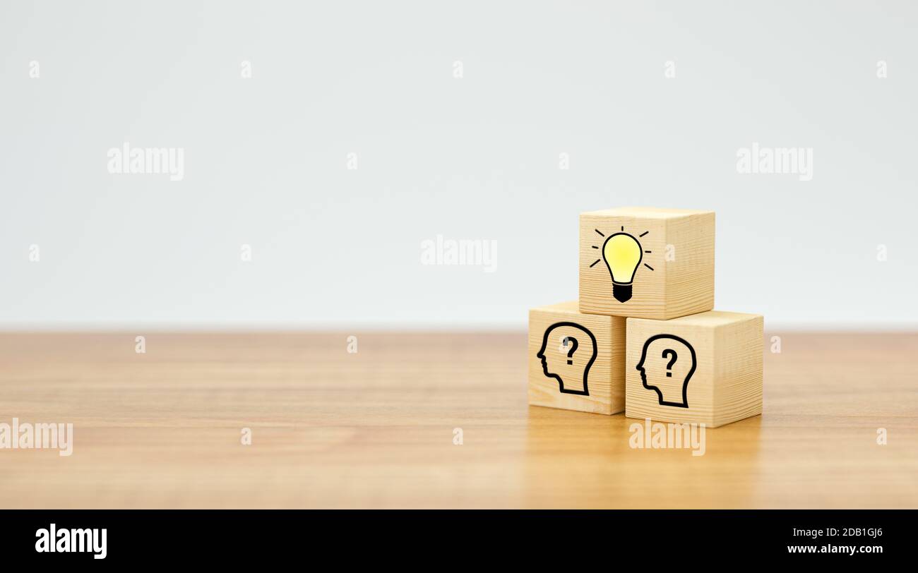 cubes showing a brainstorming session on wooden surface and white ...