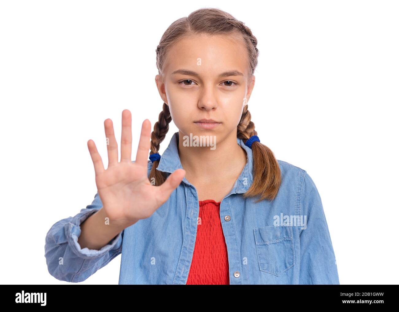 Beautiful teenage girl shows with hands a stop sign on an isolated ...