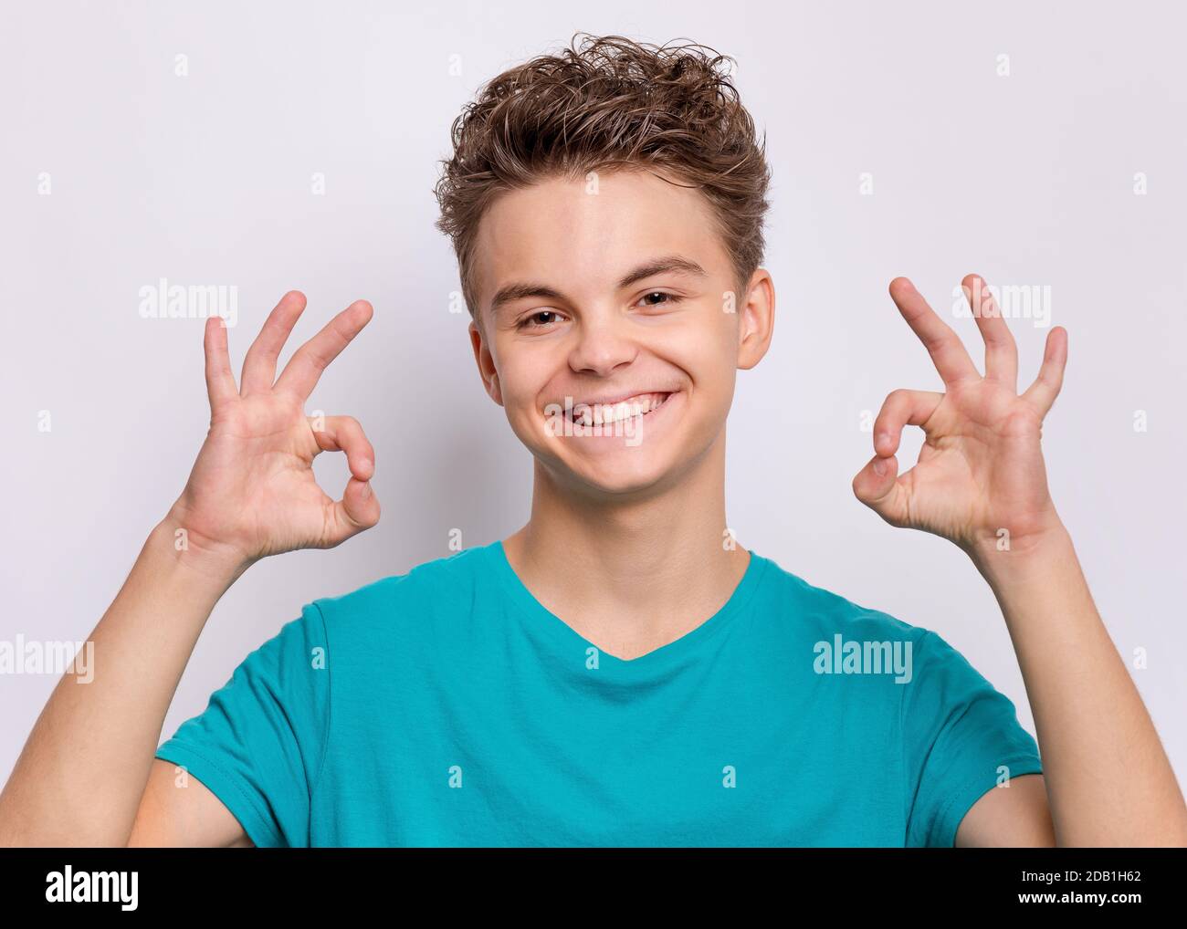 Handsome teen boy laughing looking very happy Stock Photo - Alamy