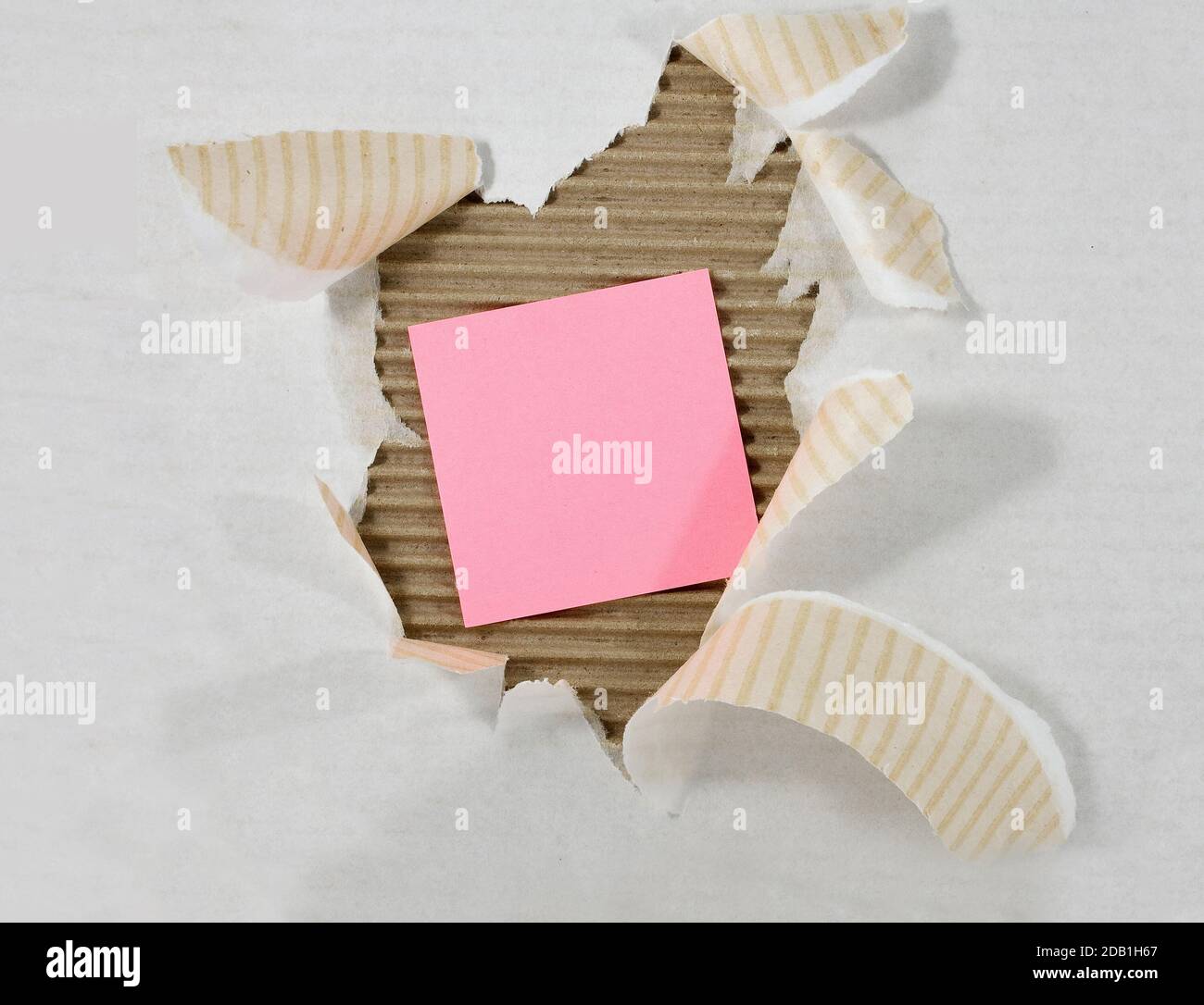 Post-It Note attached torn corrugated cardboard Stock Photo - Alamy