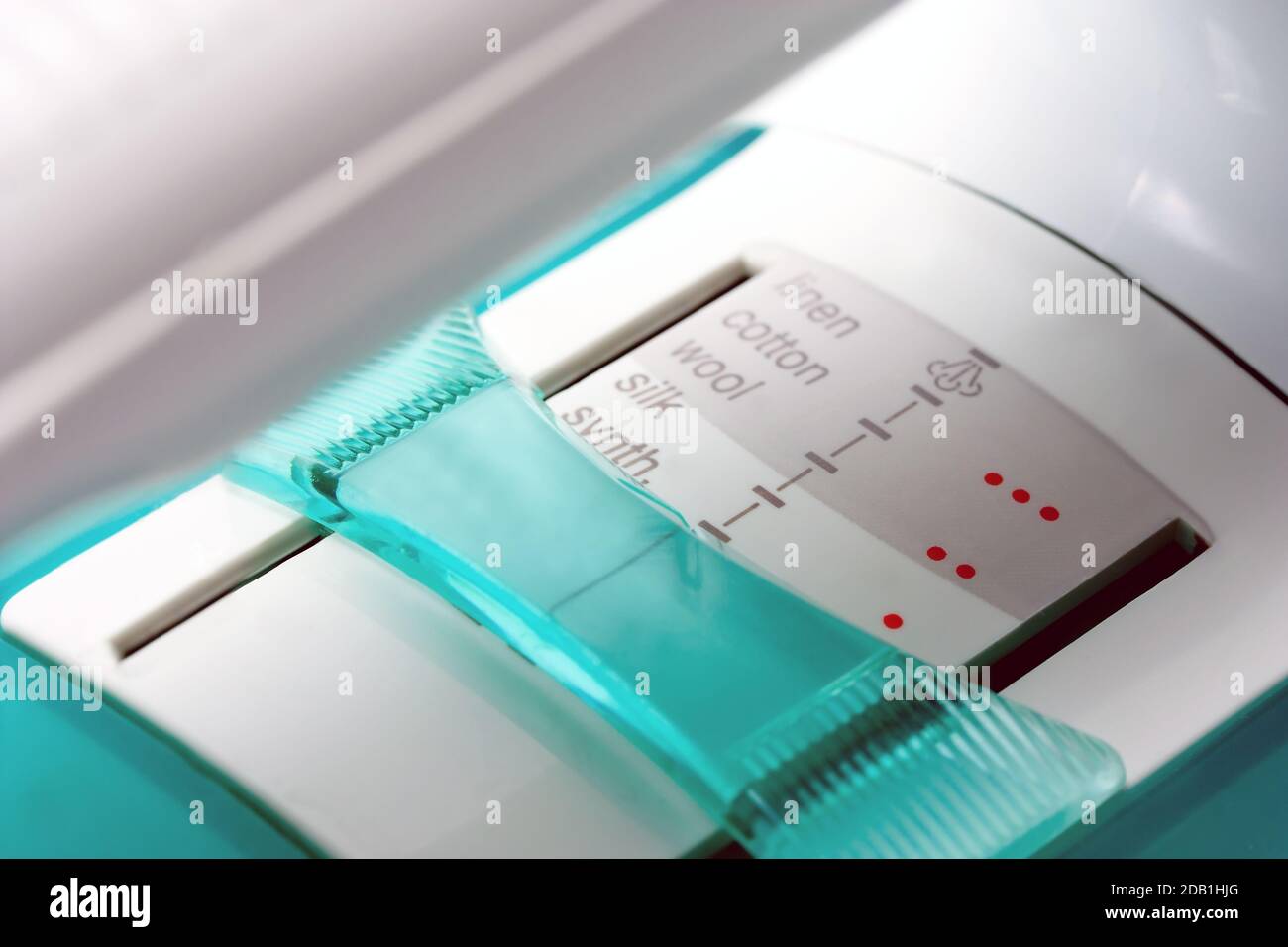 electric iron temperature control on a white background Stock Photo - Alamy