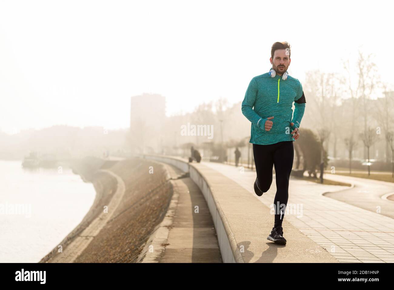 Young fitness man running in urban area Stock Photo - Alamy