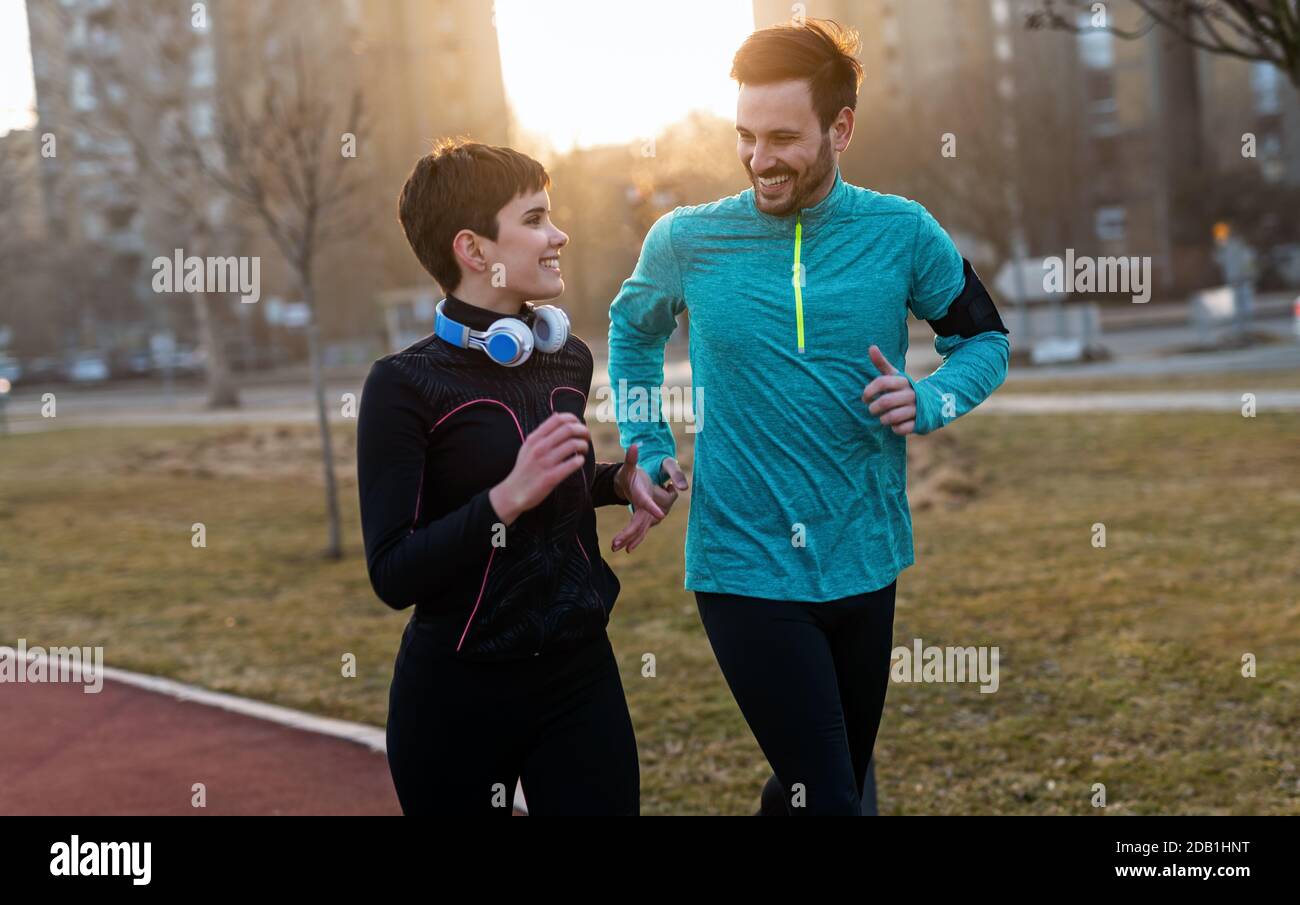 Fitness, sport, friendship and lifestyle concept. Smiling sporty couple ...