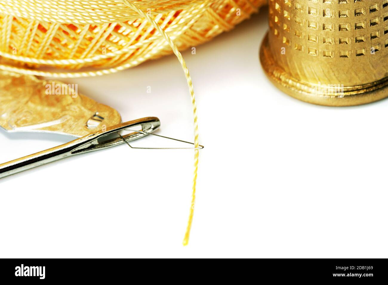 Thread in needle thimble isolated on white background Stock Photo - Alamy
