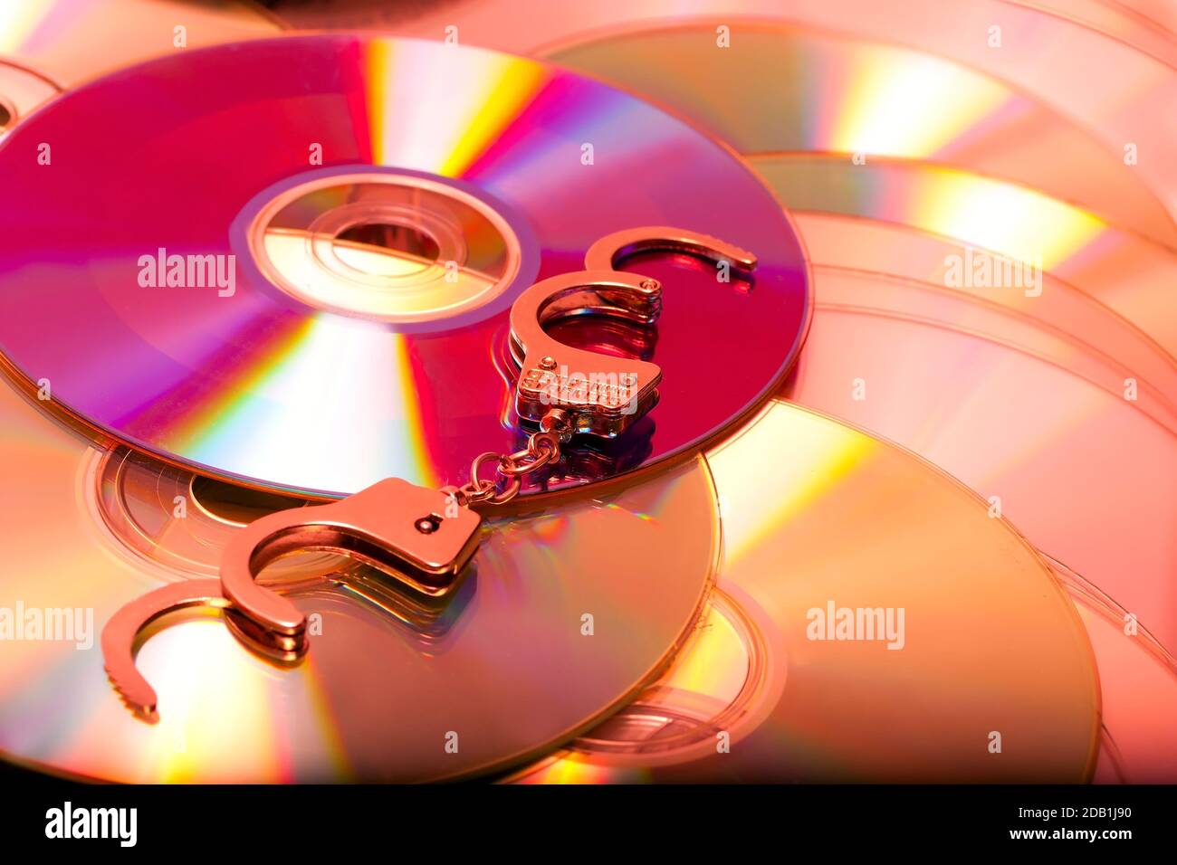 handcuffs in pile pirate dvd computer disc Stock Photo - Alamy