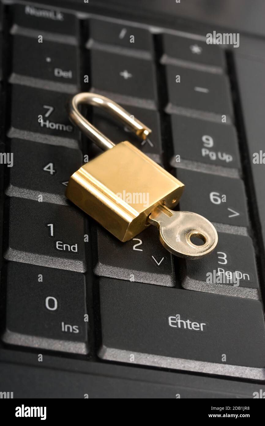 laptop keyboard and lock key background Stock Photo - Alamy